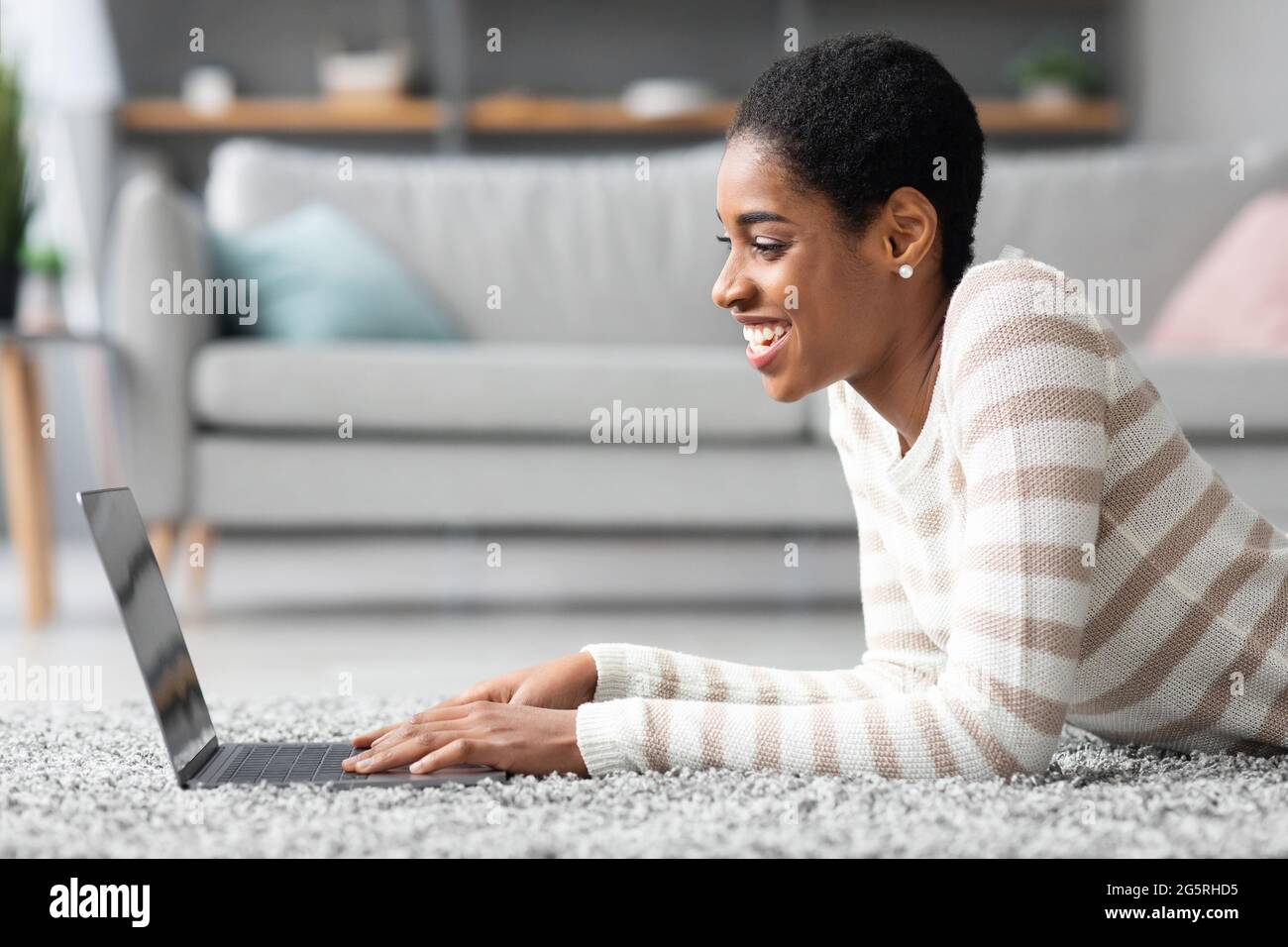 Side View Of Cheerful Black Woman Using Laptop Computer At Home Stock ...