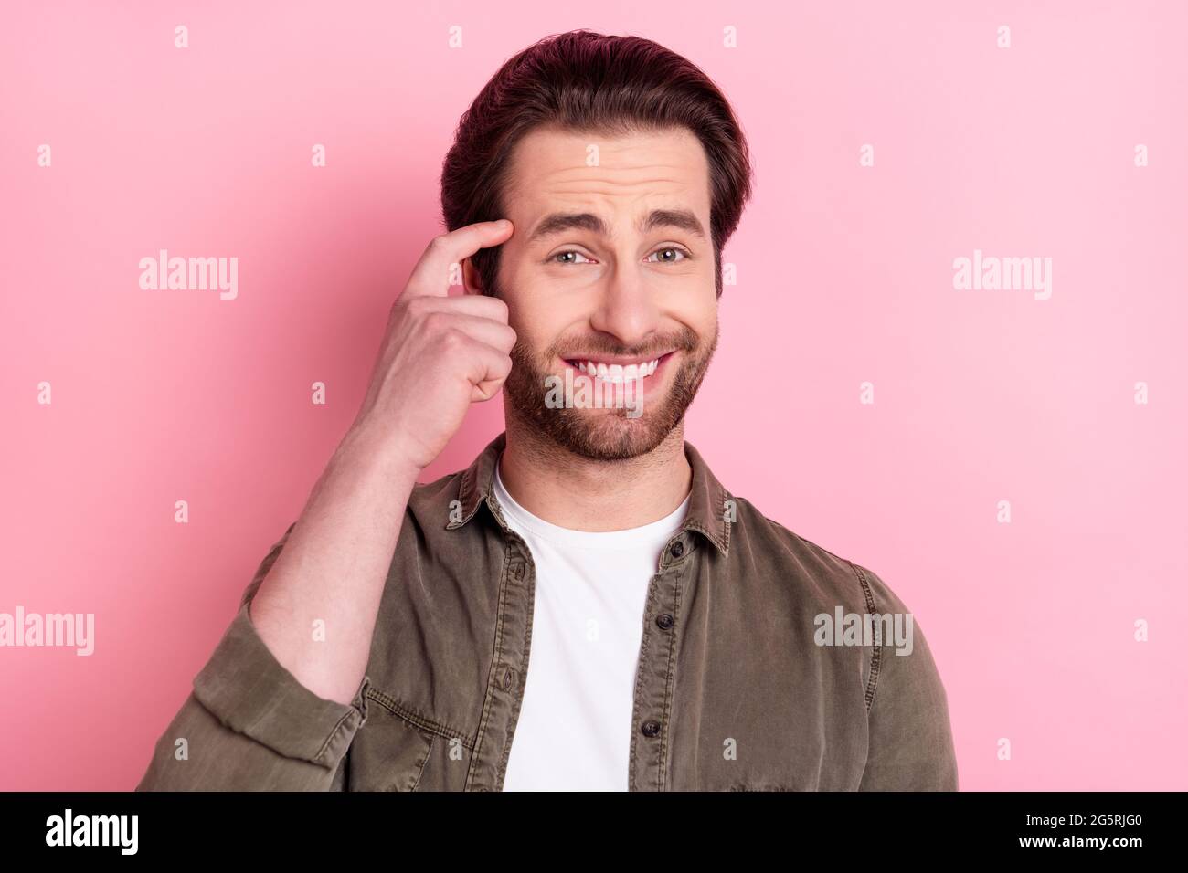 Photo of young cheerful man happy positive smile finger touch head ...