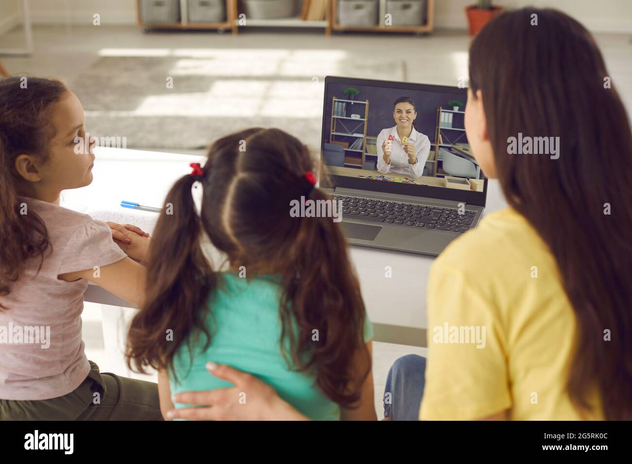 Teacher with computer and children hi-res stock photography and images ...
