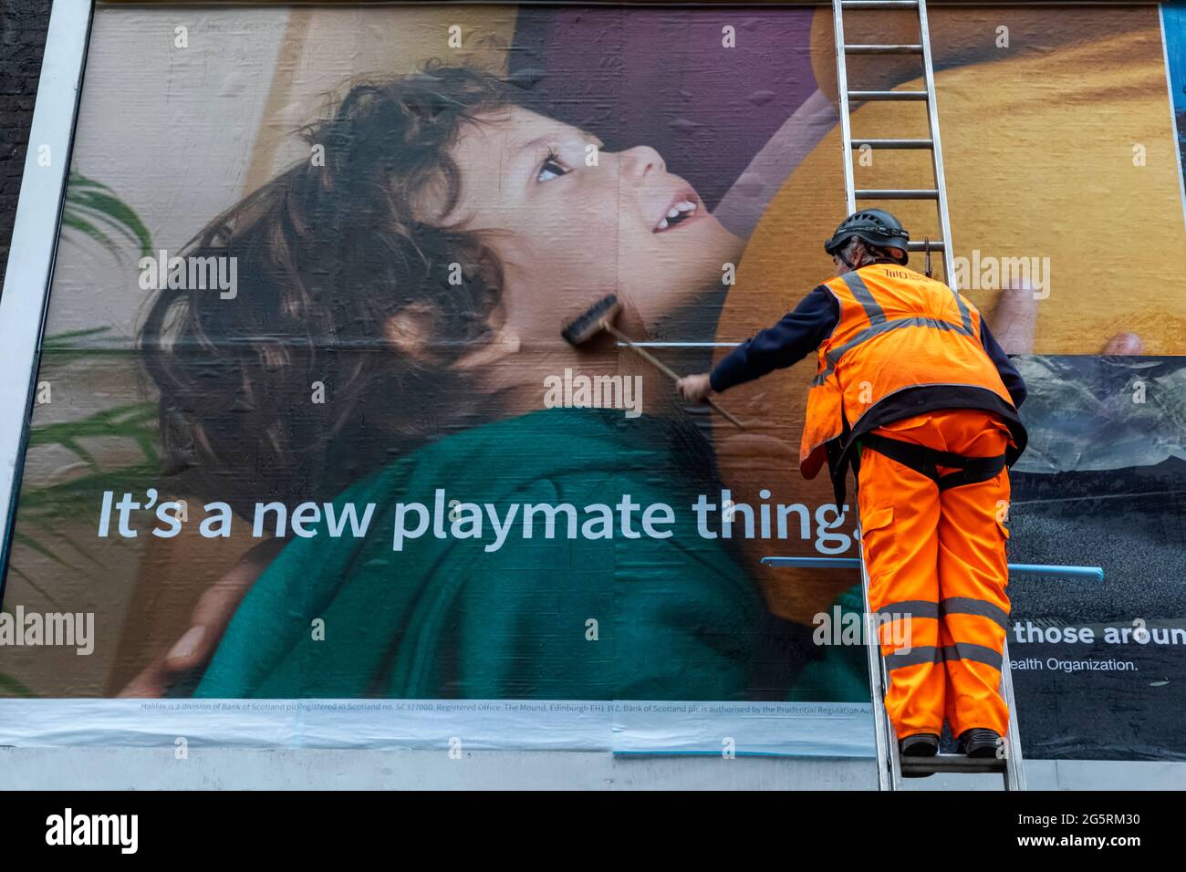 Putting up poster hi-res stock photography and images - Alamy