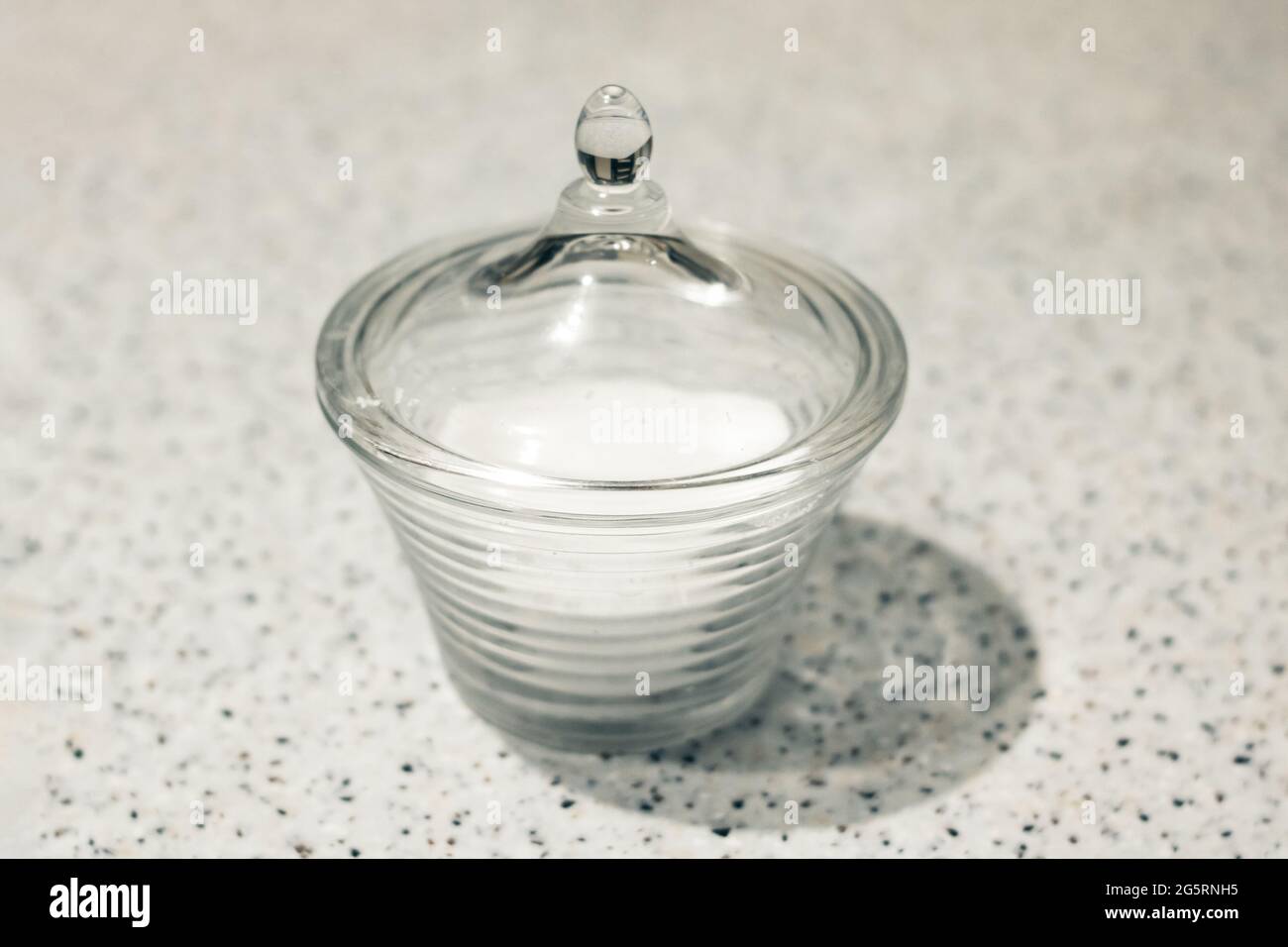 Retro style glass jar of salt on the table Stock Photo - Alamy
