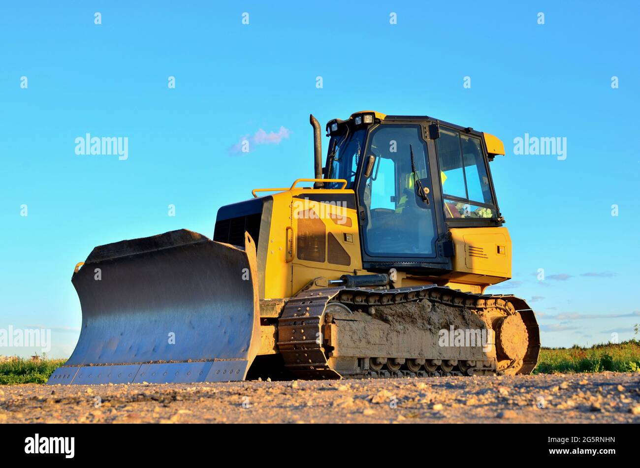 Dozer with buckets at construction site. Bulldozer during land clearing ...