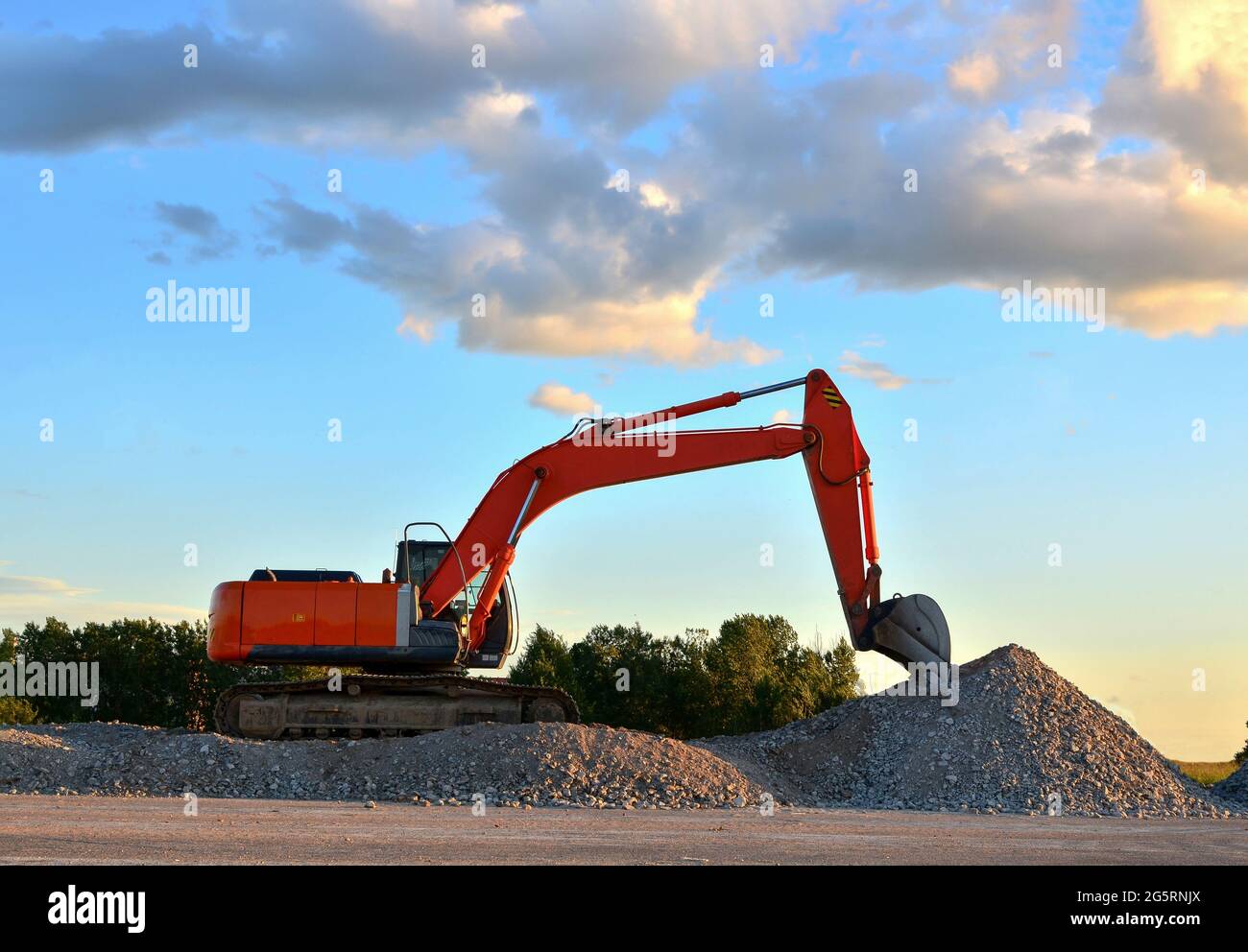 Excavator loads of stone and rubble for processing into cement or ...