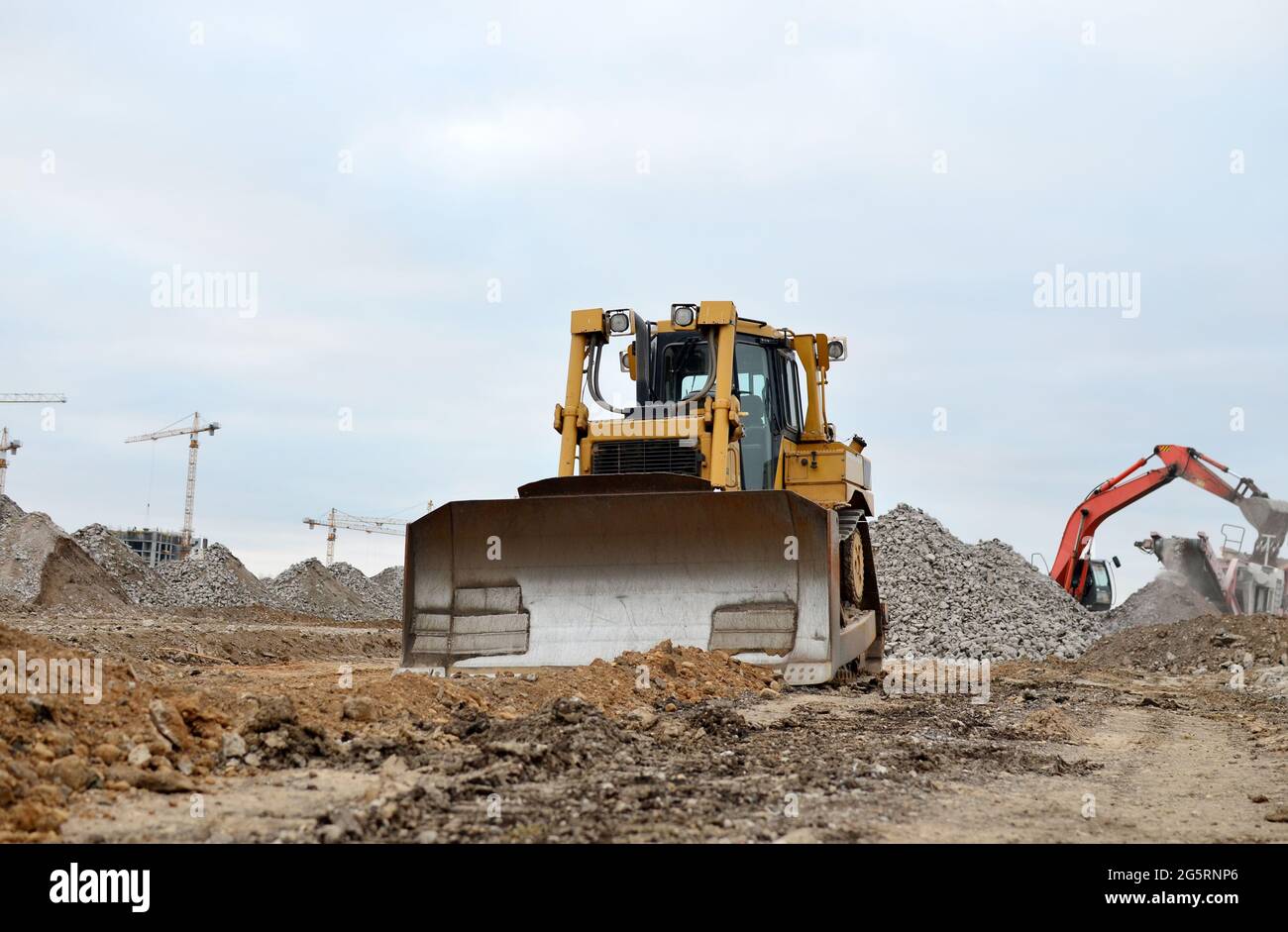 Dozer with buckets at construction site. Bulldozer during land clearing ...