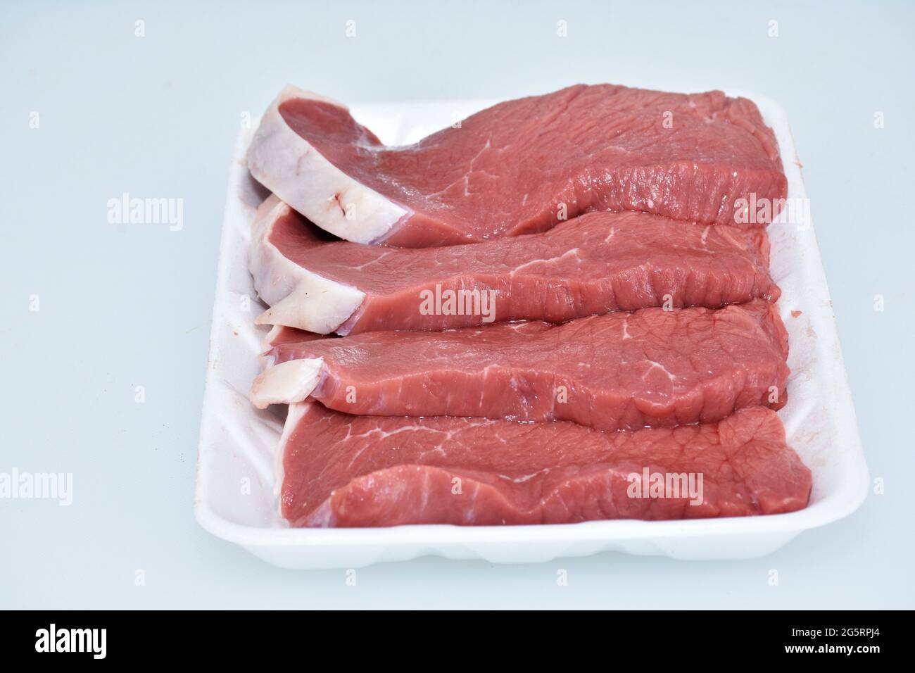 fresh boneless lamb meat sliced pieces decorated in plate on white ...