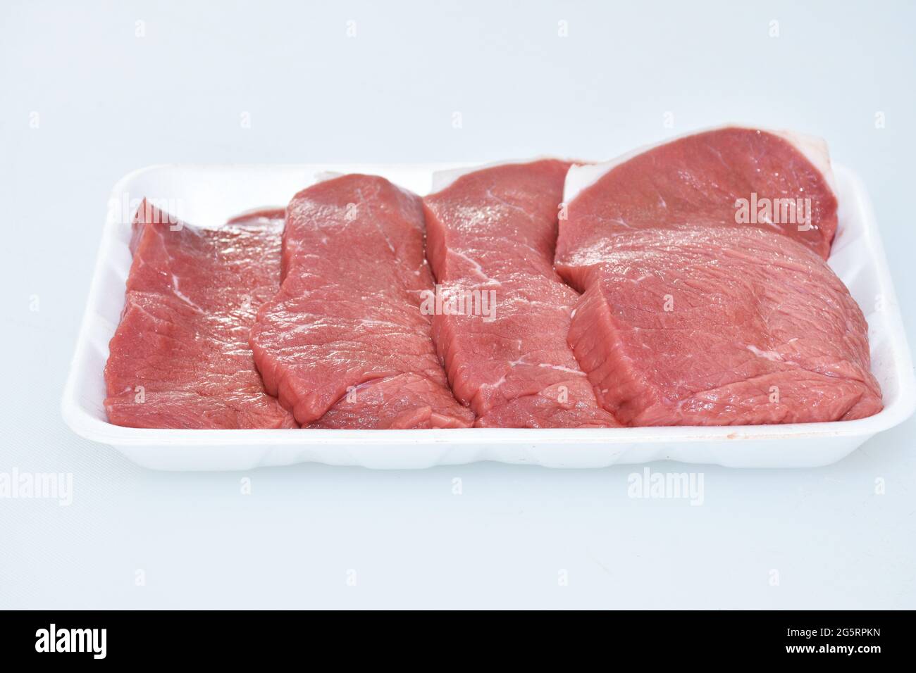 fresh boneless lamb meat sliced pieces decorated in plate on white ...