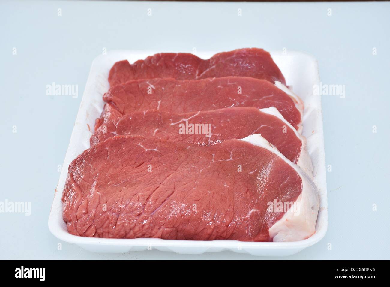fresh boneless lamb meat sliced pieces decorated in plate on white ...
