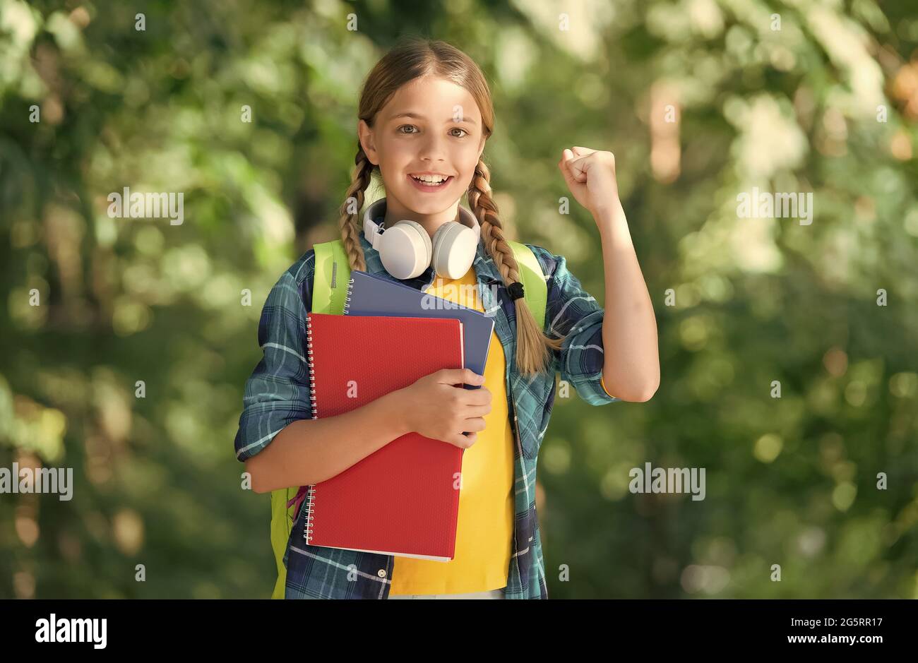 Homework done. Happy kid celebrate back to school. Little child hold ...
