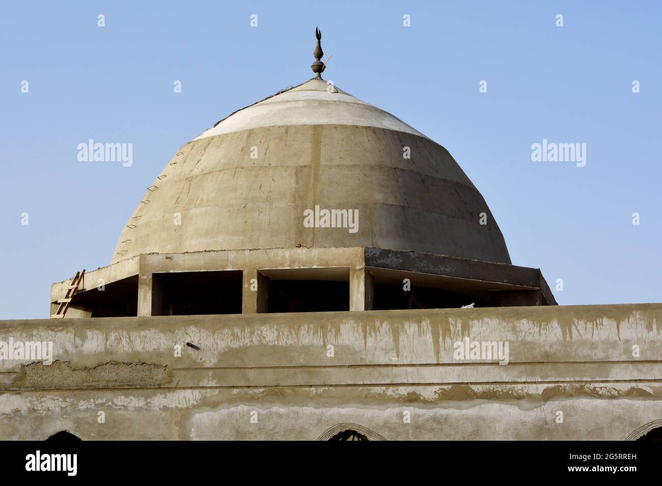 A new mosque under construction against the sunny blue sky with the ...
