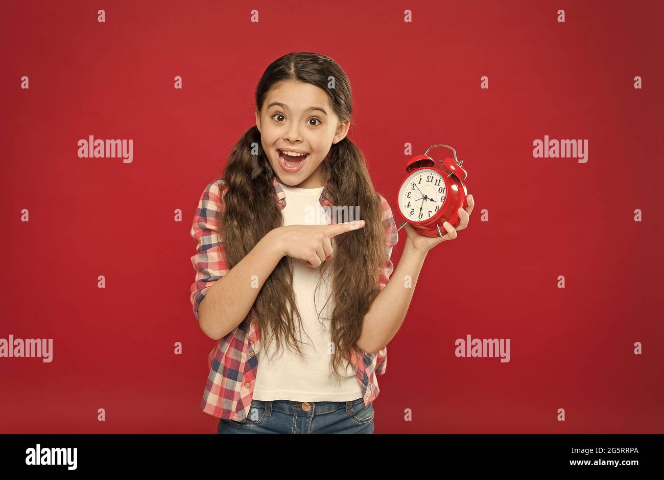 just look at that. teen kid showing time on clock. girl pointing finger ...
