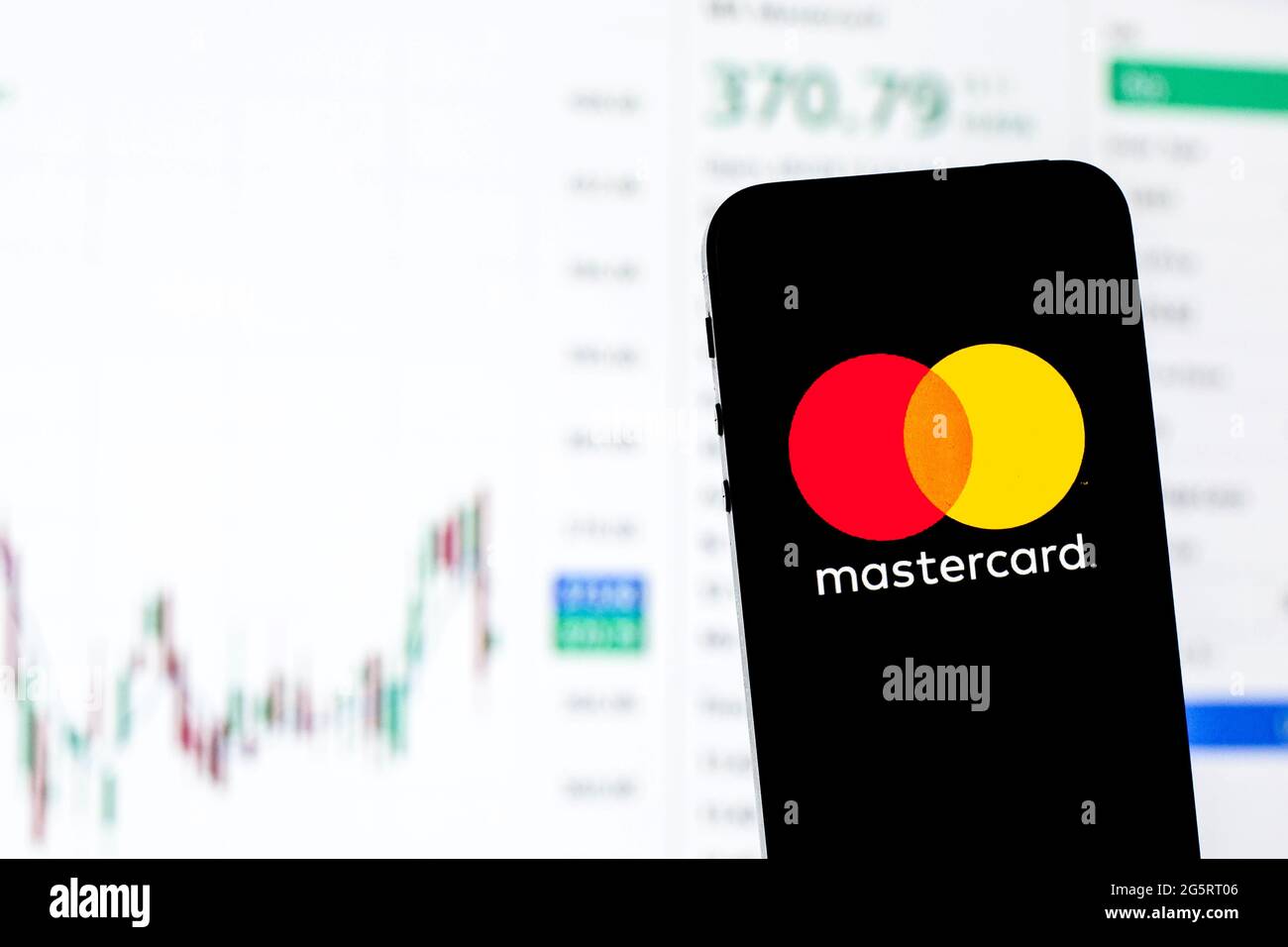 In this photo illustration a Mastercard logo seen displayed on a ...