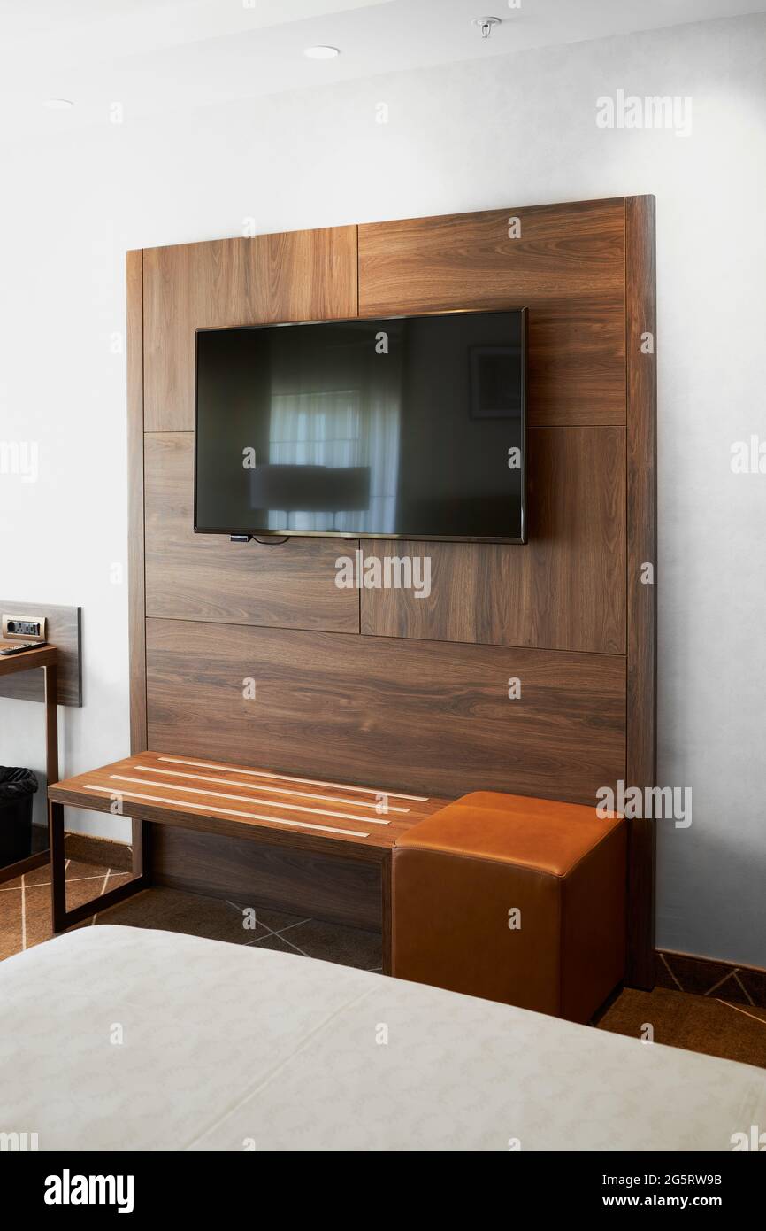 Modern hotel bedroom with a television set Stock Photo - Alamy