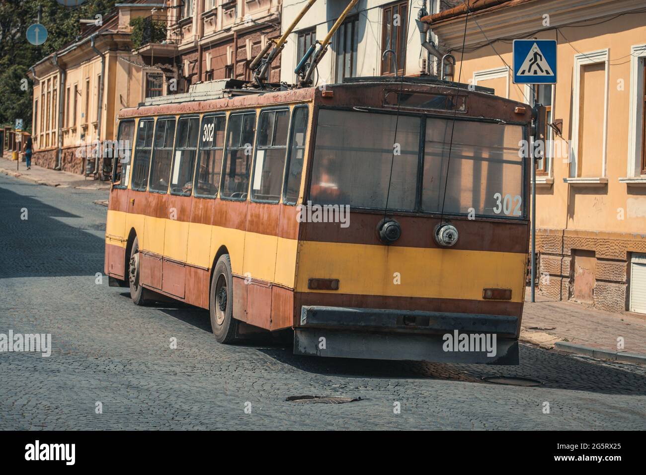 Old trolleybus carrying passengers in the city Stock Photo - Alamy