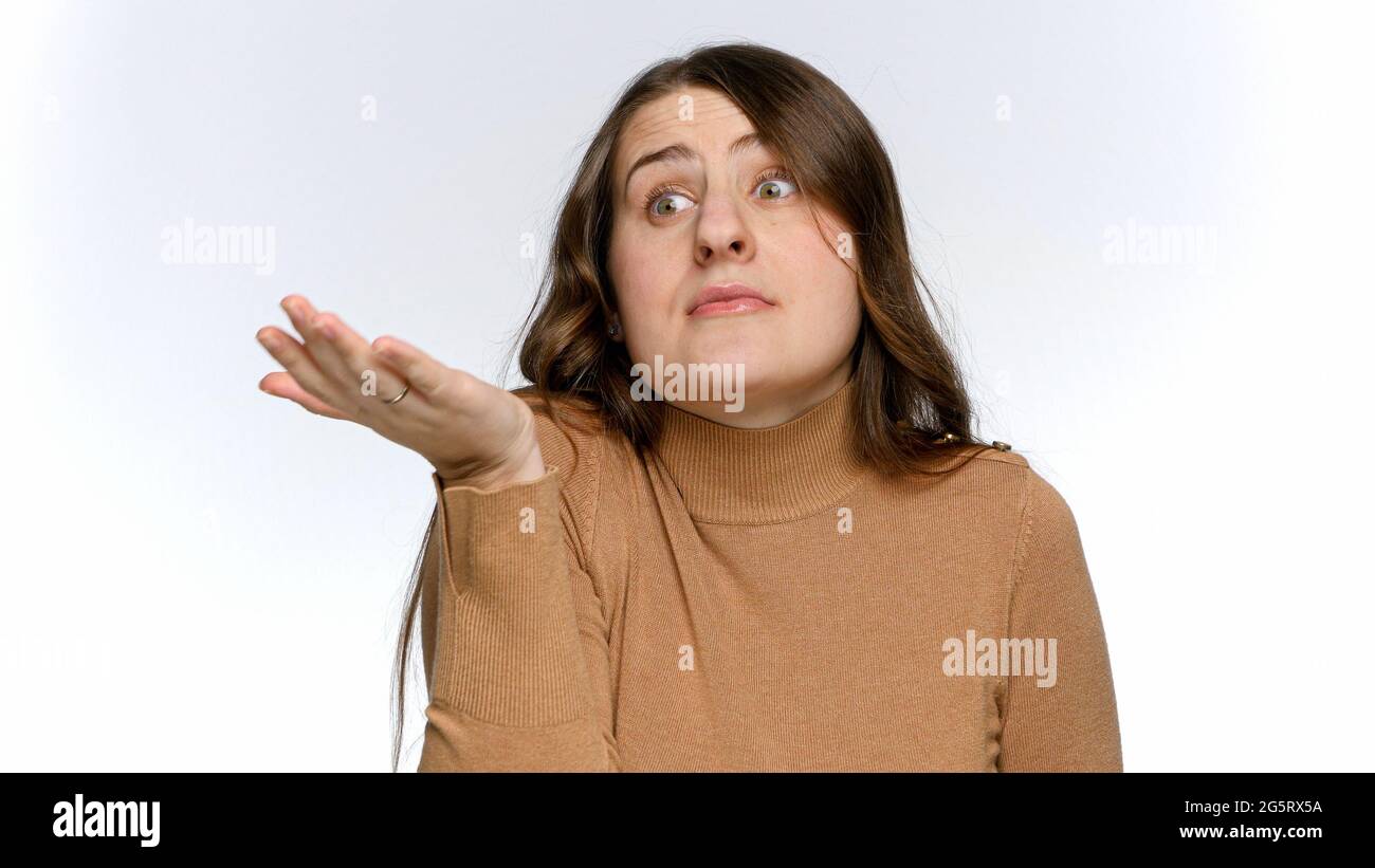 Portrait of annoyed and strssed woman making wtf hand gesture over ...