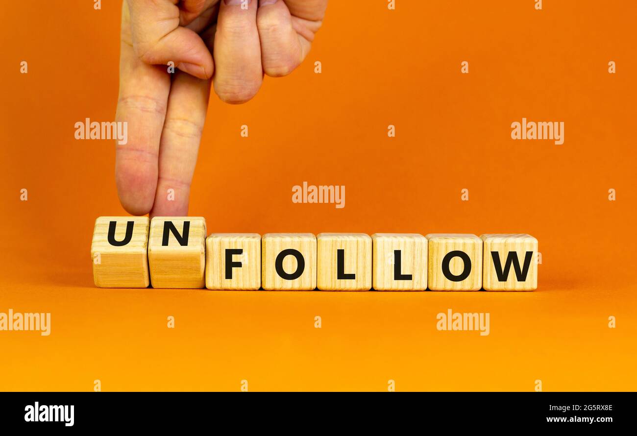 Follow or unfollow symbol. Businessman turns wooden cubes and changes ...