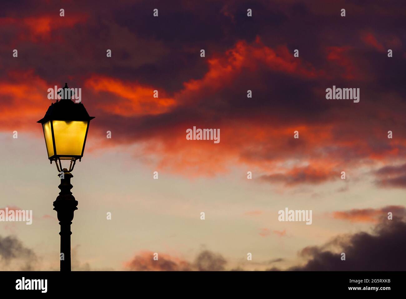 Old fashioned street lamp against beautiful sunset sky and colorful ...