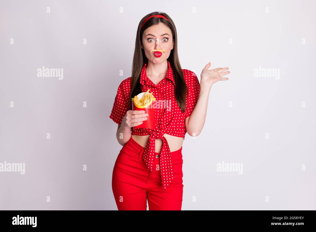 Photo of funky childish girl hold box french fries fake mustache pout ...