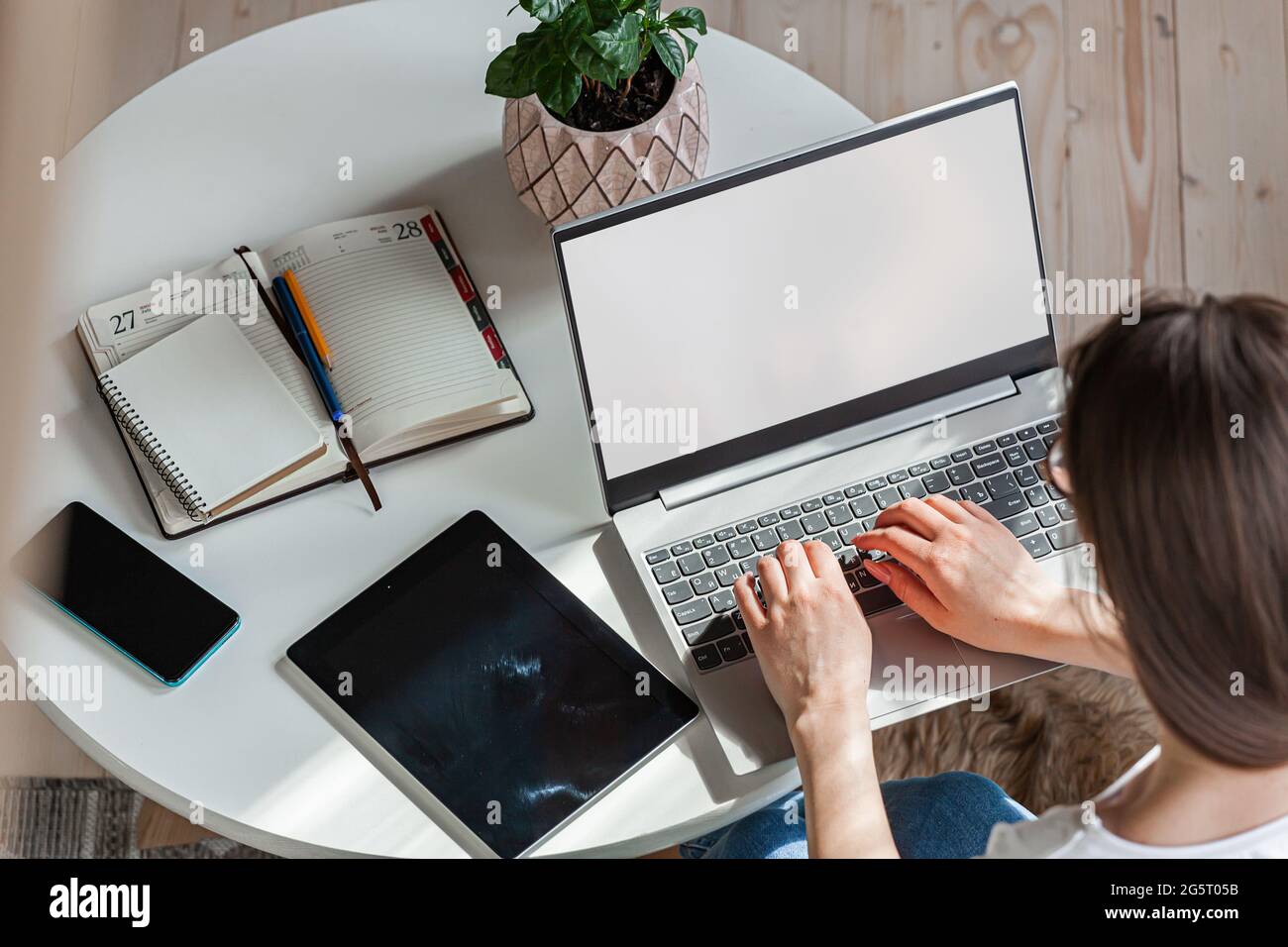Young woman using laptop screen blank, mock up, work home, top view ...