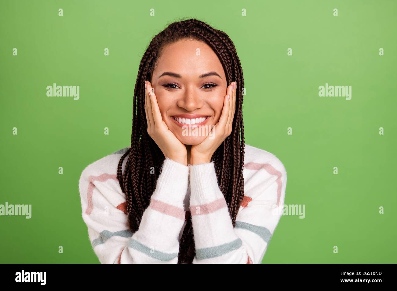 Photo of cheerful young dark skin nice adorable woman hold hands cheeks ...