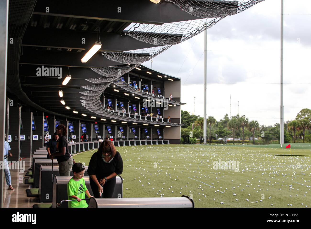 Day time view of people playing at TopGolf entertainment building in ...