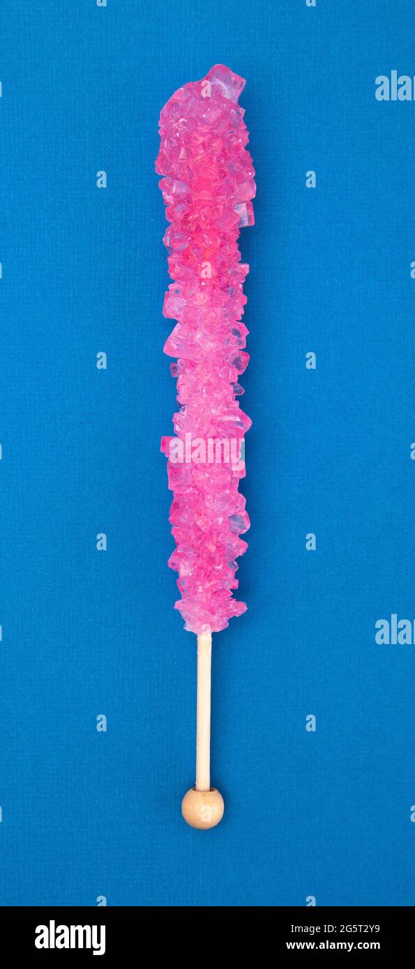 Sweet Pink Rock Candy on a Blue Background Stock Photo - Alamy