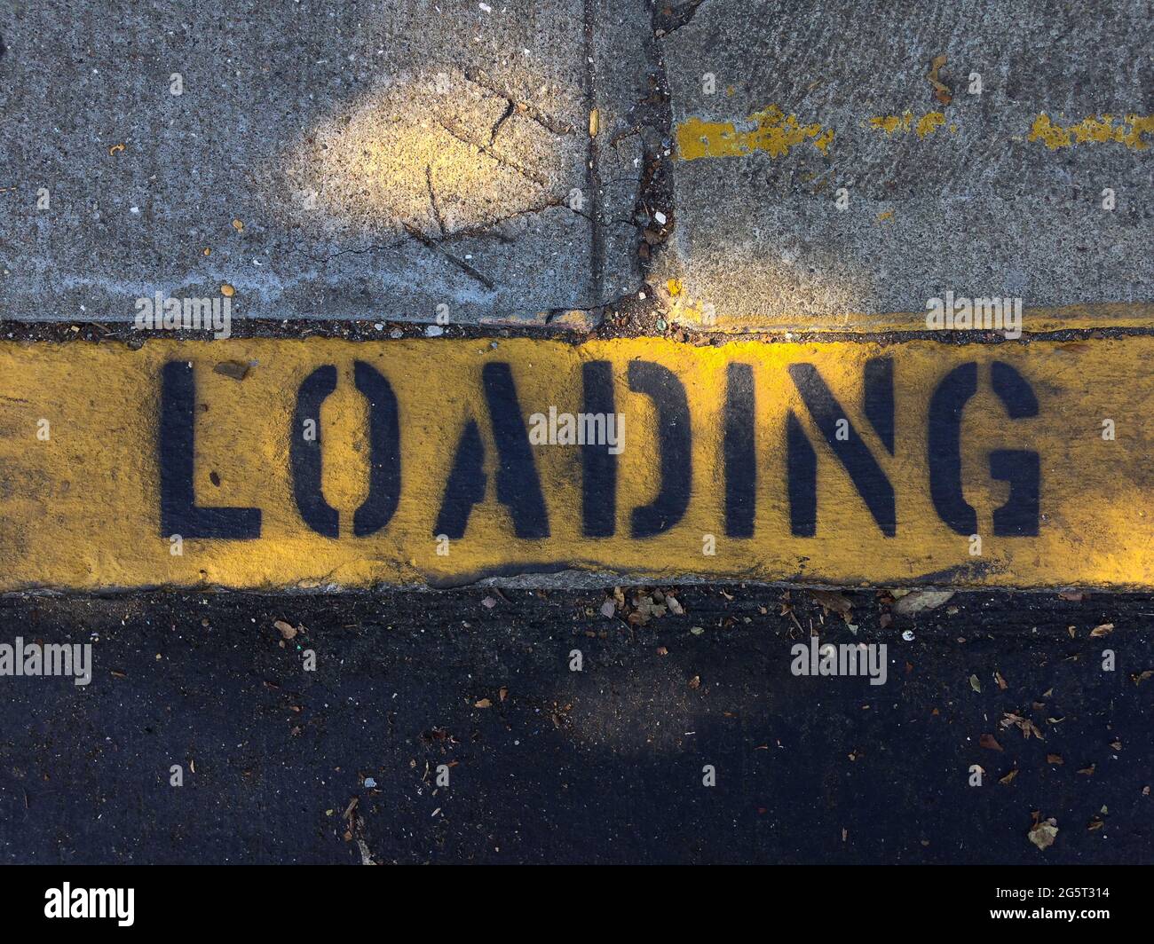 Loading sign written on street pavement Stock Photo - Alamy