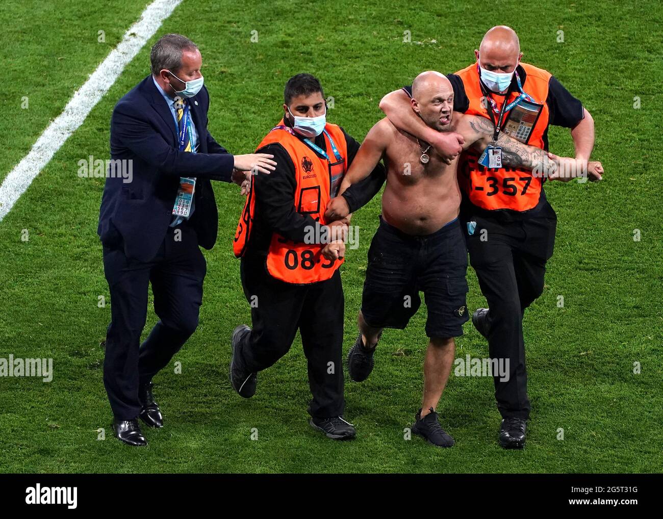 A pitch invader is removed by security during the UEFA Euro 2020 round ...