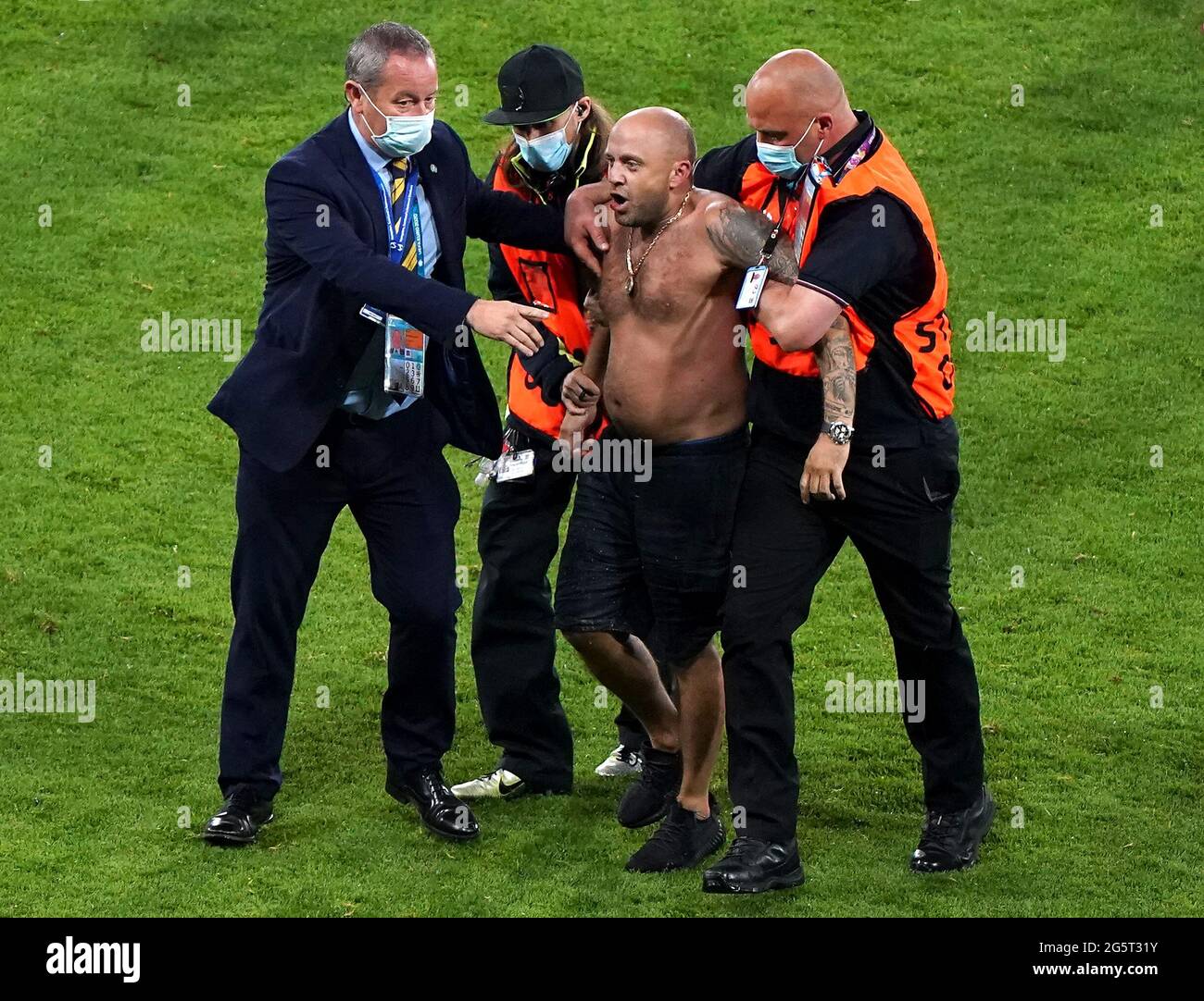 A pitch invader is removed by security during the UEFA Euro 2020 round ...