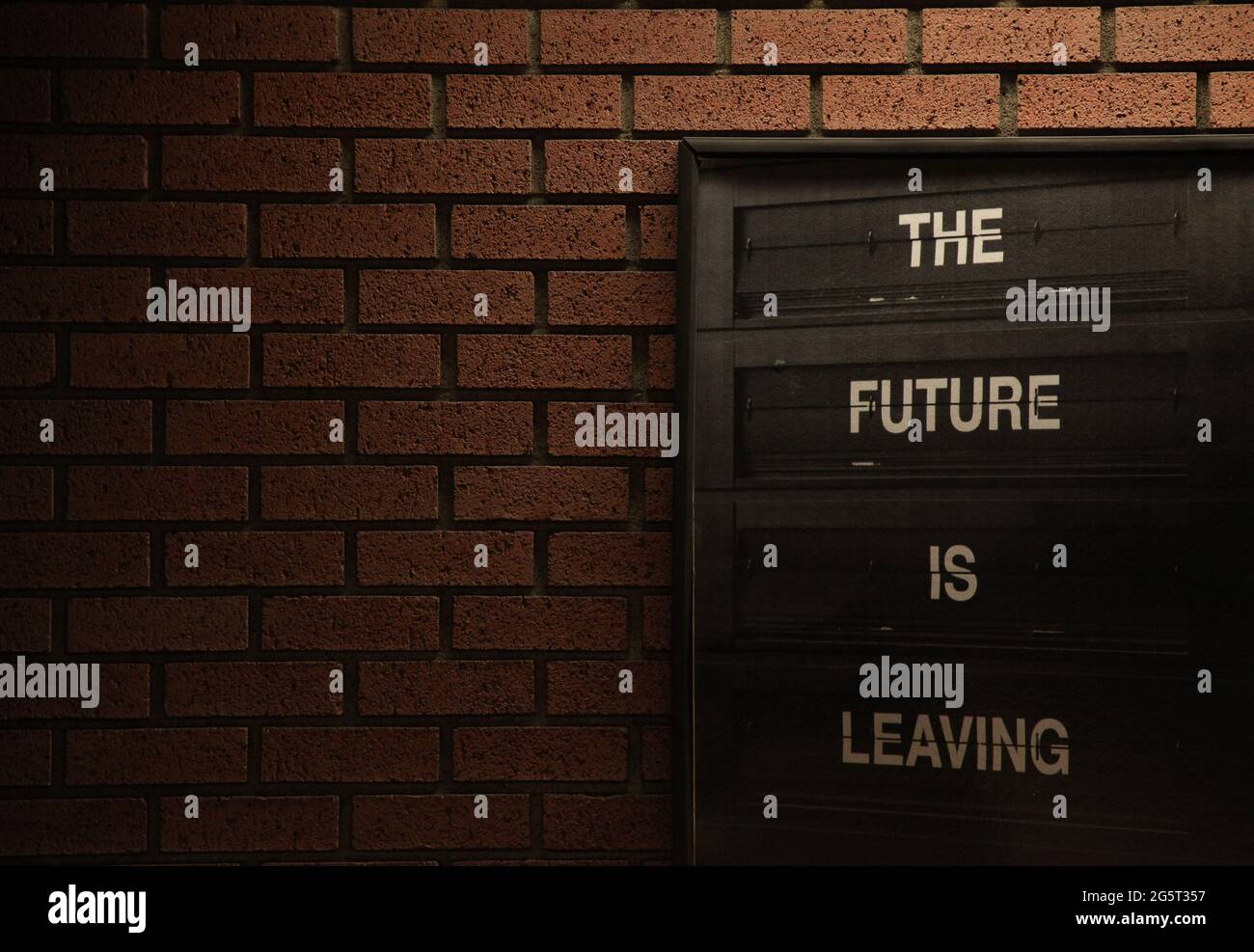 The future is leaving sign on a brick wall Stock Photo - Alamy