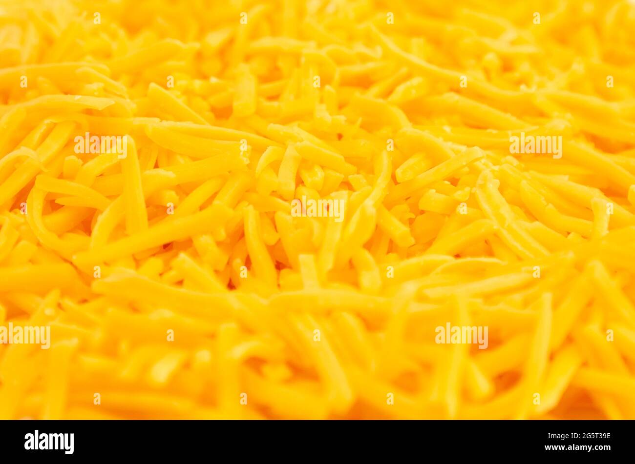 A Background of Grated Orange Cheddar Cheese Stock Photo - Alamy