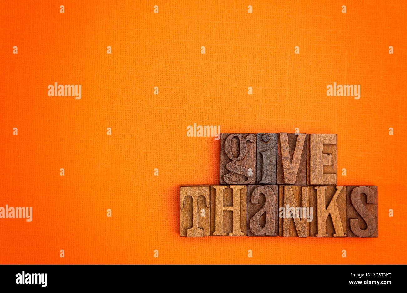 An Autumn Background with the Words Saying Give Thanks in Block Letters ...