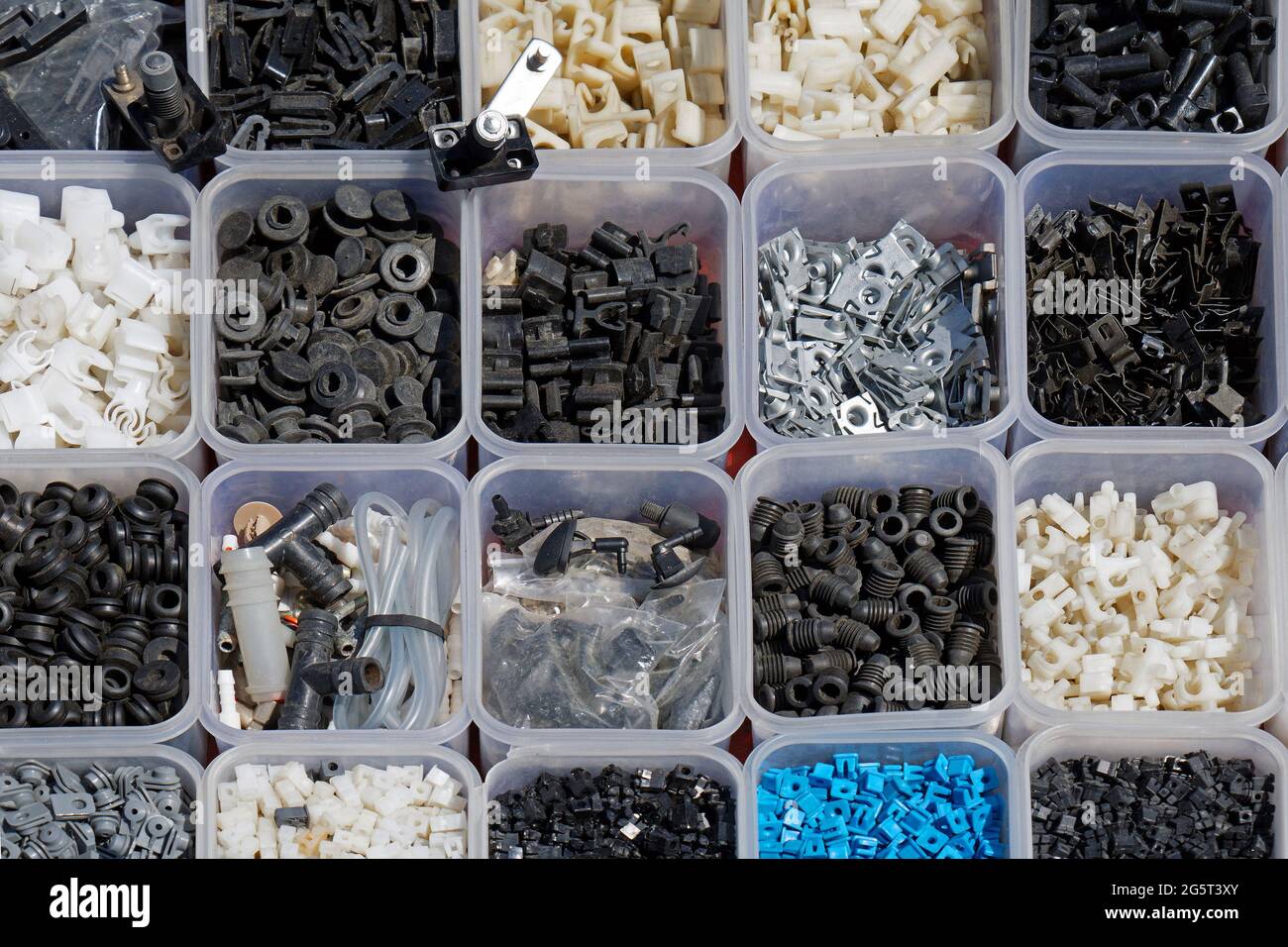Small plastic car parts inside boxes sold on market Stock Photo - Alamy