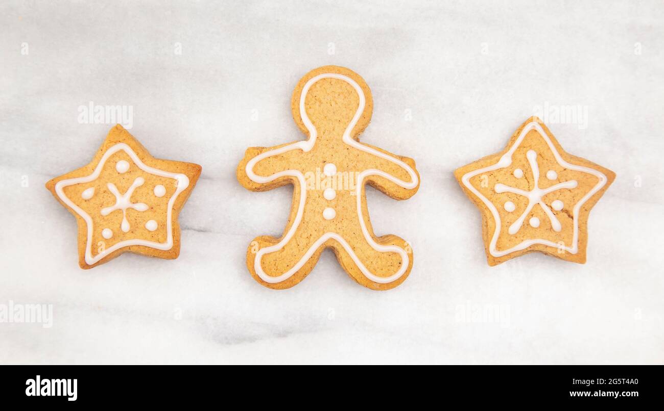 Three Gingerbread Cookies in a Row on a Marble Counter Stock Photo - Alamy