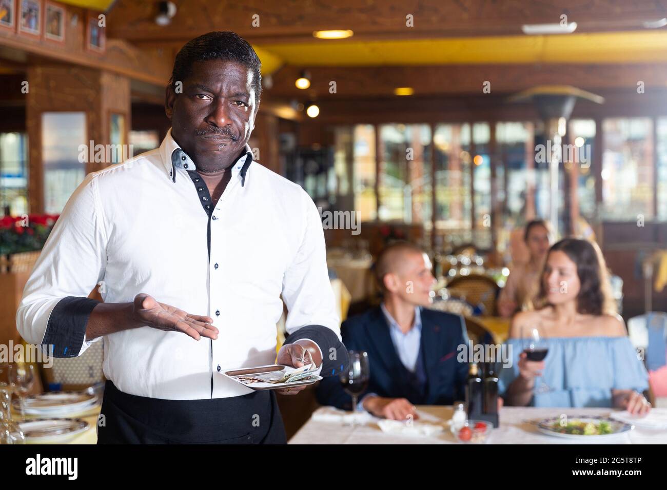 Male waiter demonstrating his upset with little tips from restaurant ...
