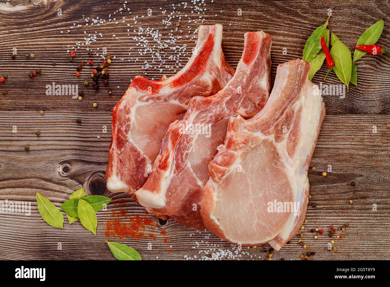 Pork cut meat chop with bay leaf and red pepper. Close up Stock Photo ...