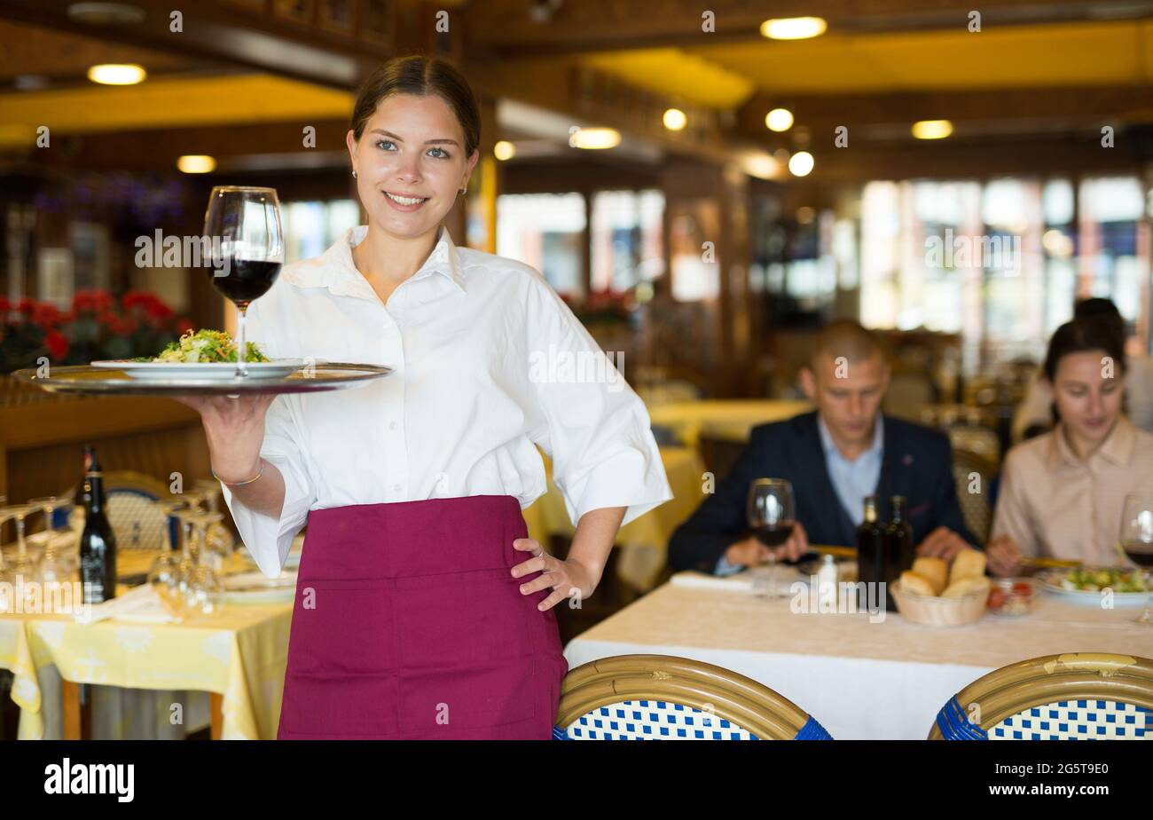 Waiter standing with serving tray, recommending dishes in restaurant ...