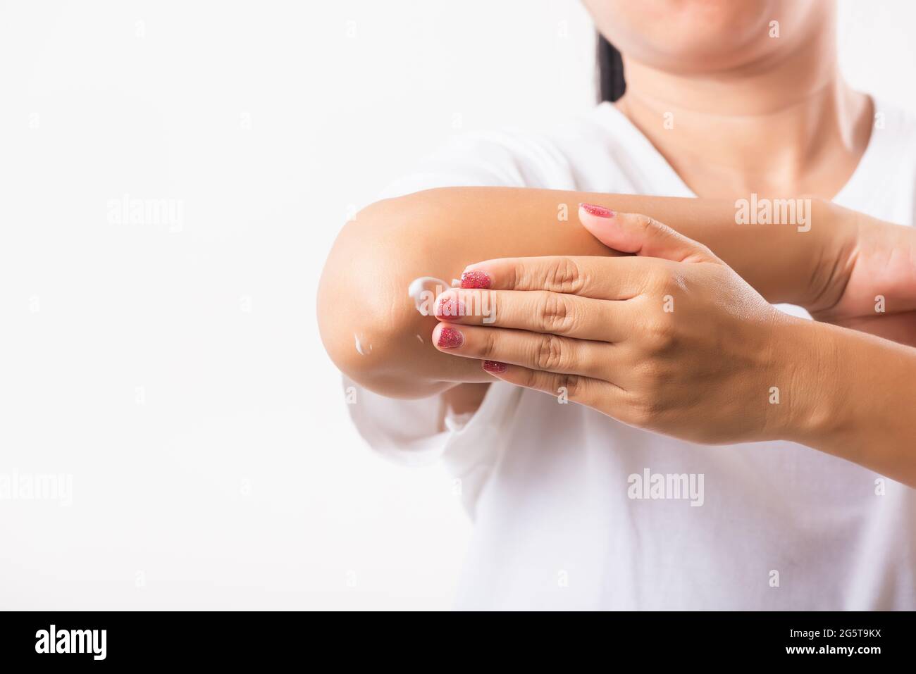 Woman putting lotion on arm hi-res stock photography and images - Alamy