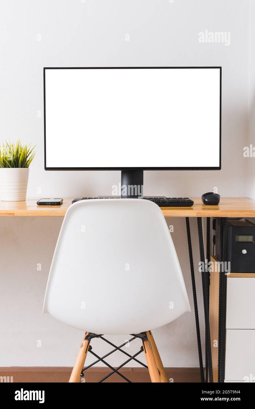 Computer monitor with white blank screen on the business desk with ...