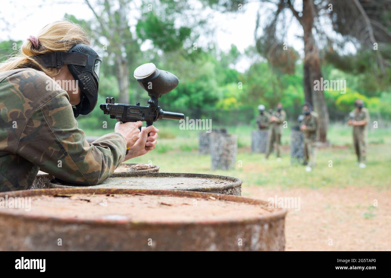 Team of friends paintball players playing together in battle Stock ...