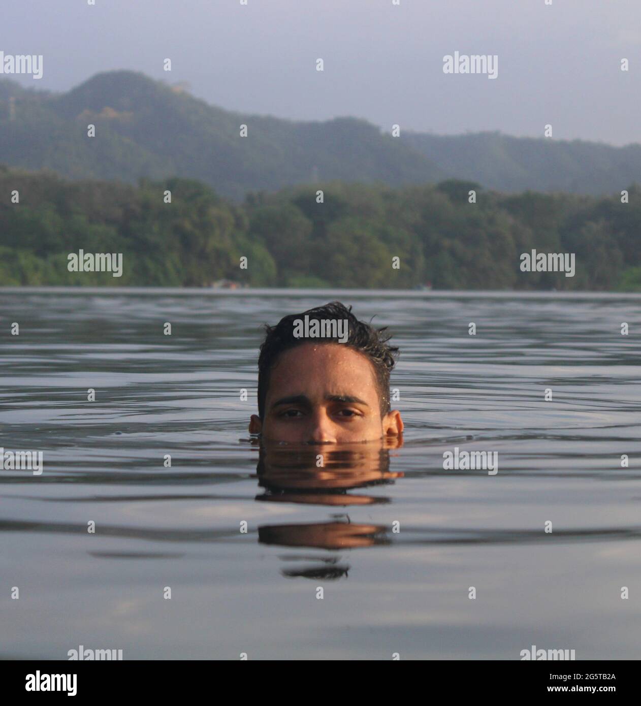 deep look of a young man while he is immersed in the river Stock Photo ...
