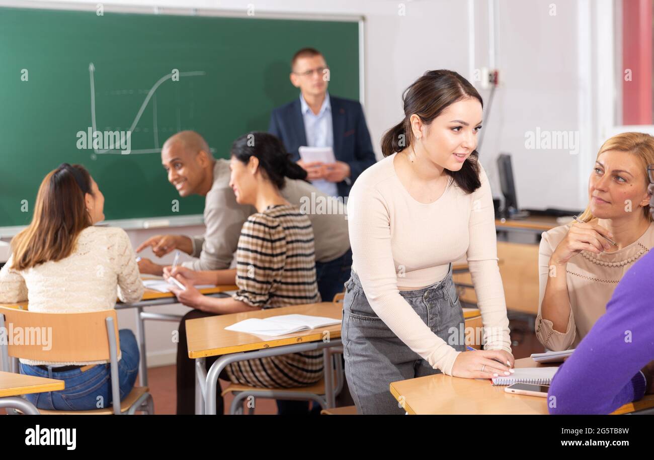 Students discussing course material in groups in classroom Stock Photo ...