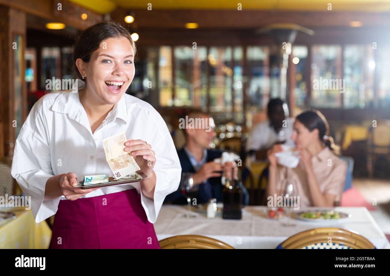 Portrait of waiter holding good tips Stock Photo - Alamy