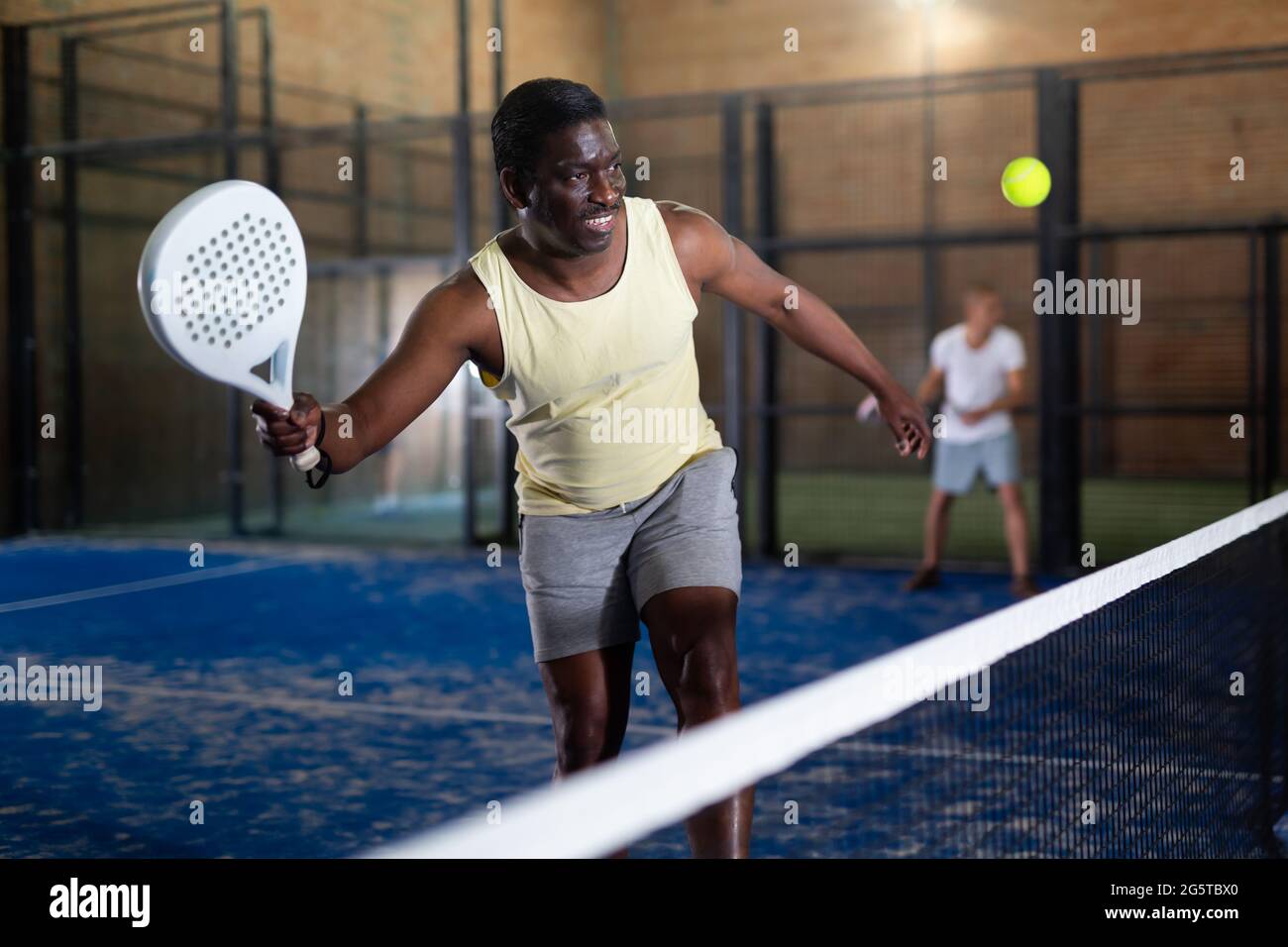 African american man playing paddle tennis Stock Photo - Alamy