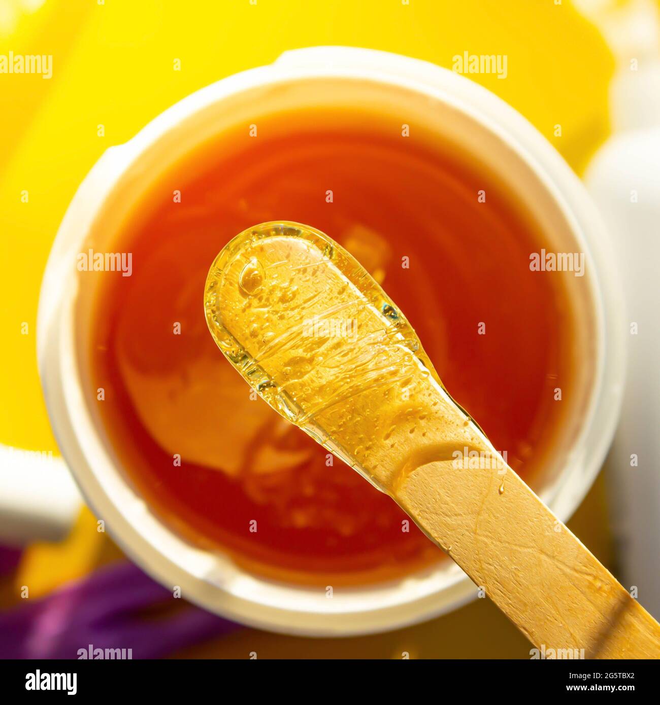 Shugaring paste. Body hair removal. Depilation. The paste drips off the ...