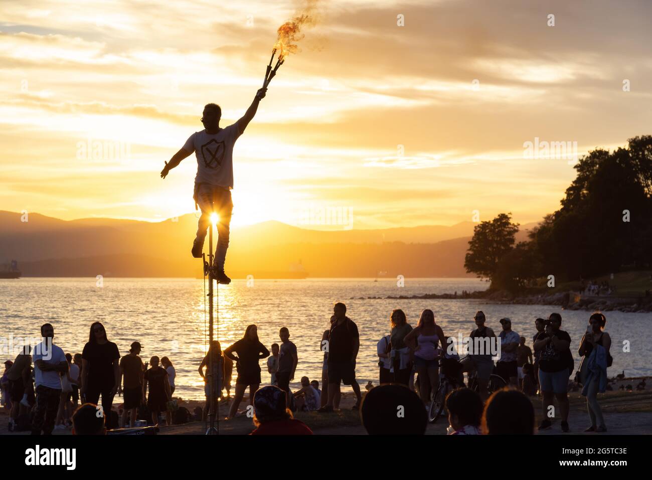 Talented Street Performer doing a show with a unicycle in front of a ...