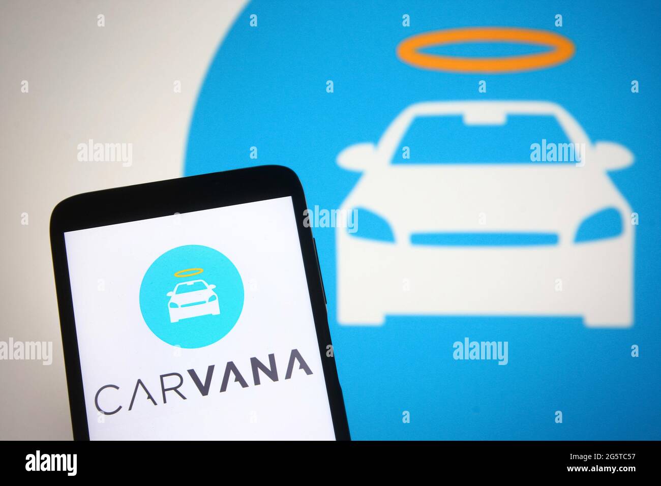 In this photo illustration, Carvana logo is seen on a smartphone screen ...