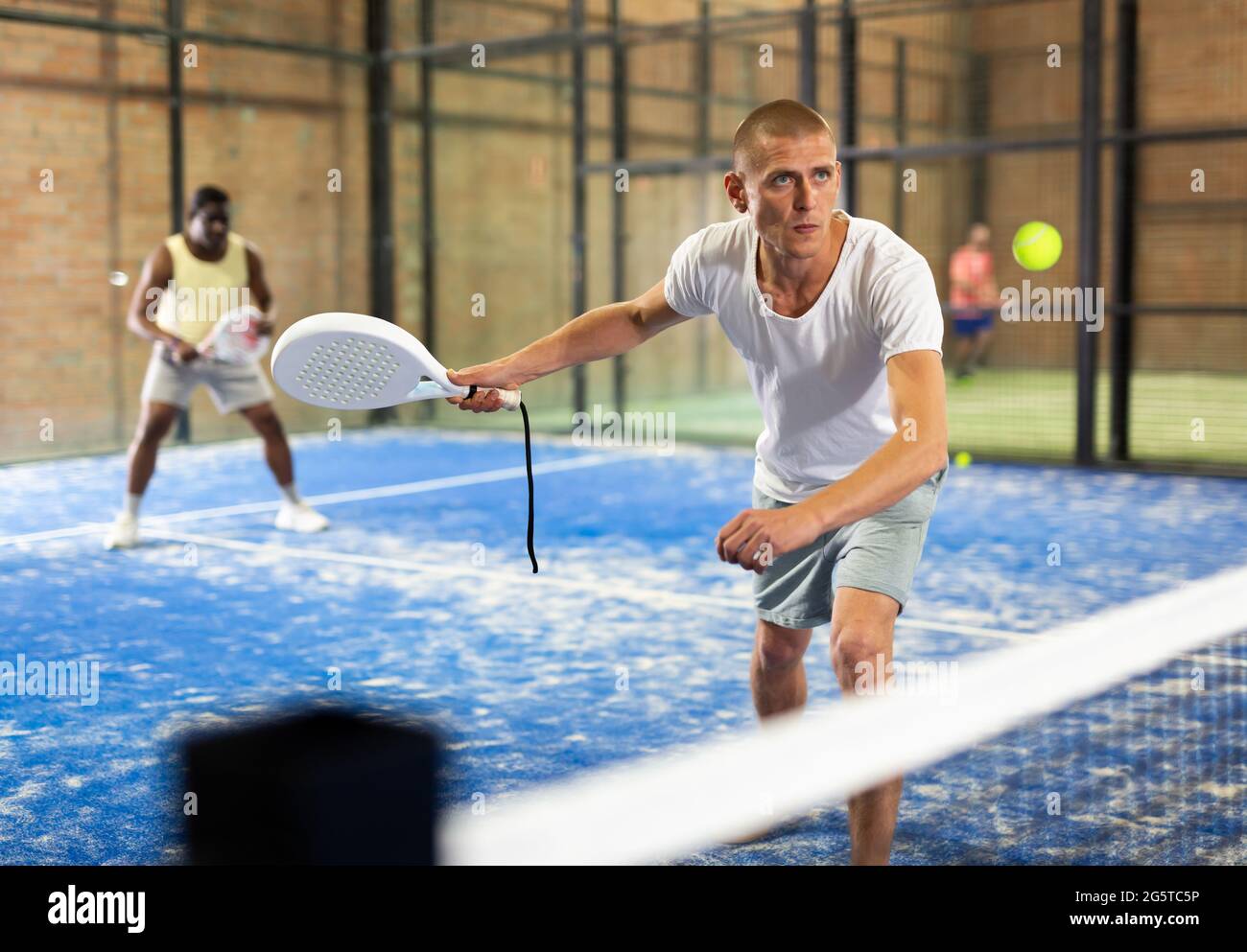 Man playing padel tennis on padel court Stock Photo - Alamy