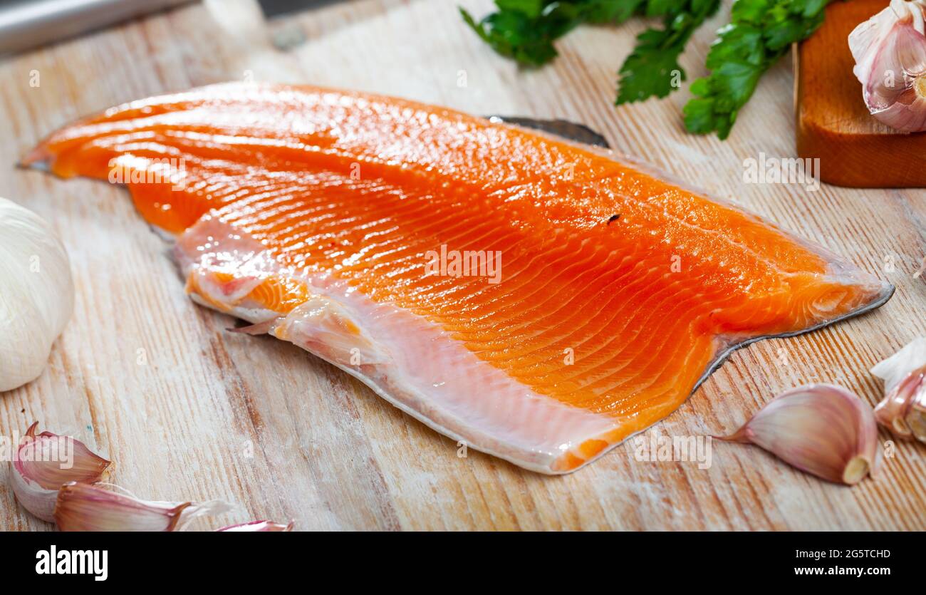 Close up of tasty raw sea trout fillet on wooden desk Stock Photo - Alamy