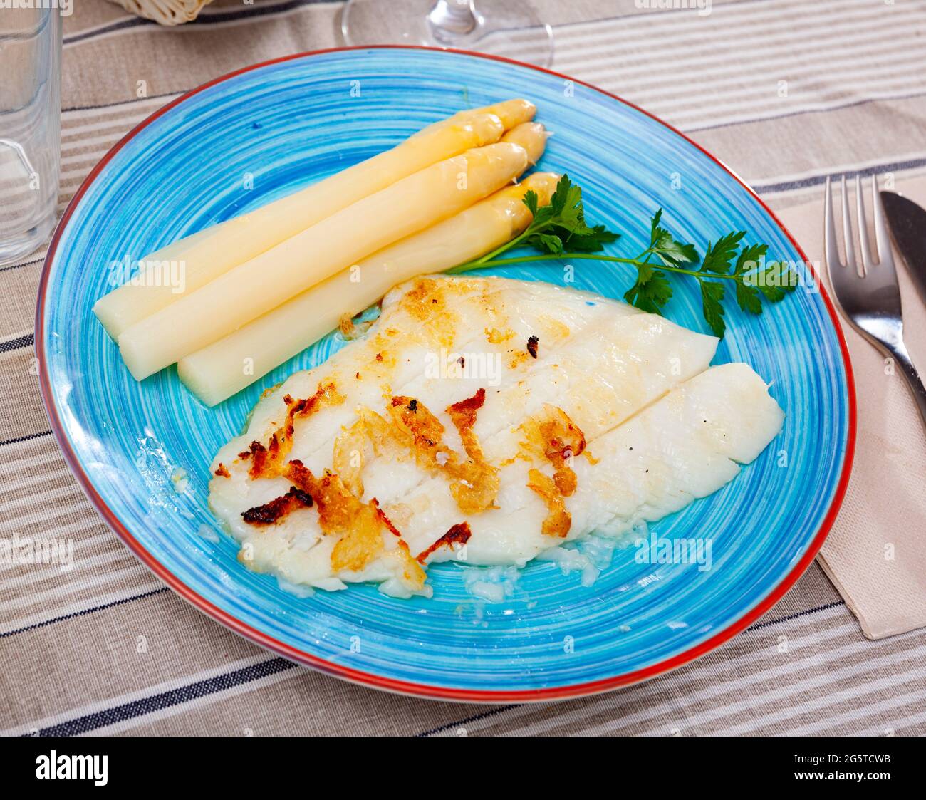 Tasty fried halibut fish fillet with asparagus and greens Stock Photo ...