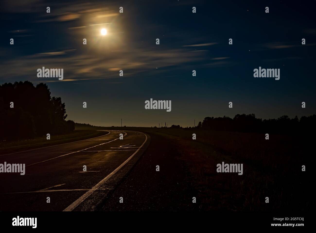 a view of a nighttime, romantic, paved, empty road Stock Photo - Alamy